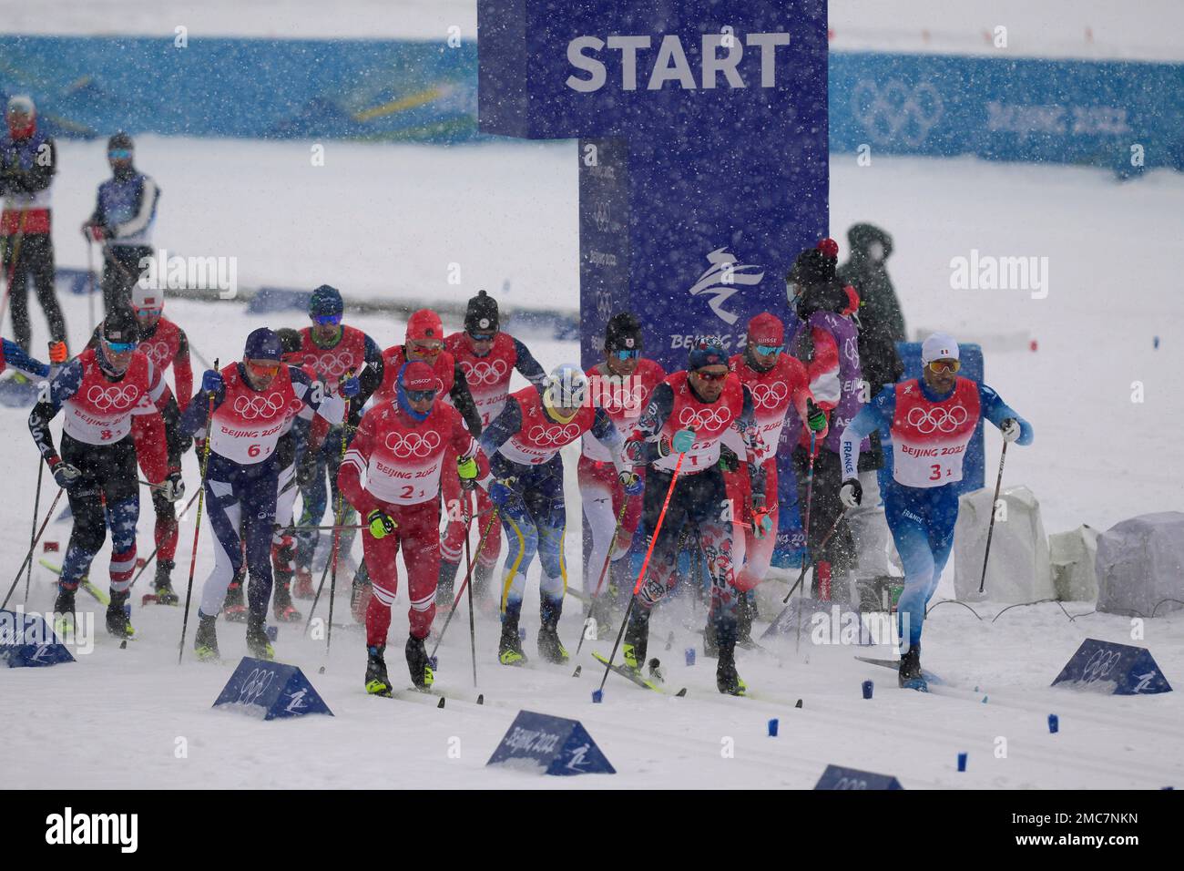 Skiers start the men's 4 x 10km relay cross-country skiing competition ...