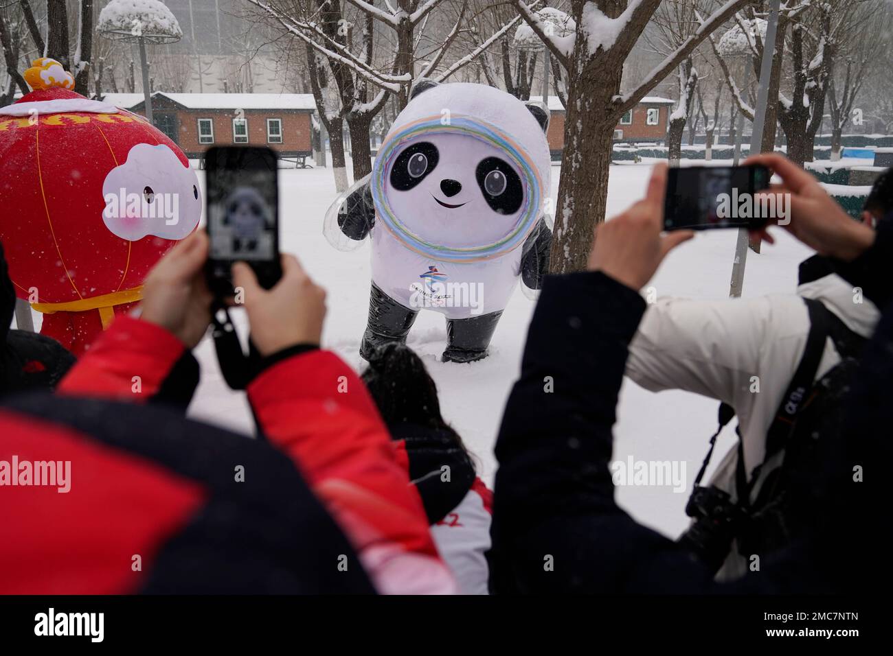 People take photos of Olympic mascot Bing Dwen Dwen, center, and Paralymic mascot Shuey Rhon ...