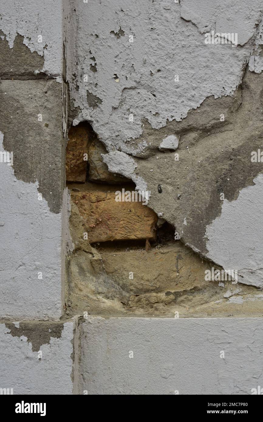 Old brick, damaged, gray wall concept background Stock Photo - Alamy