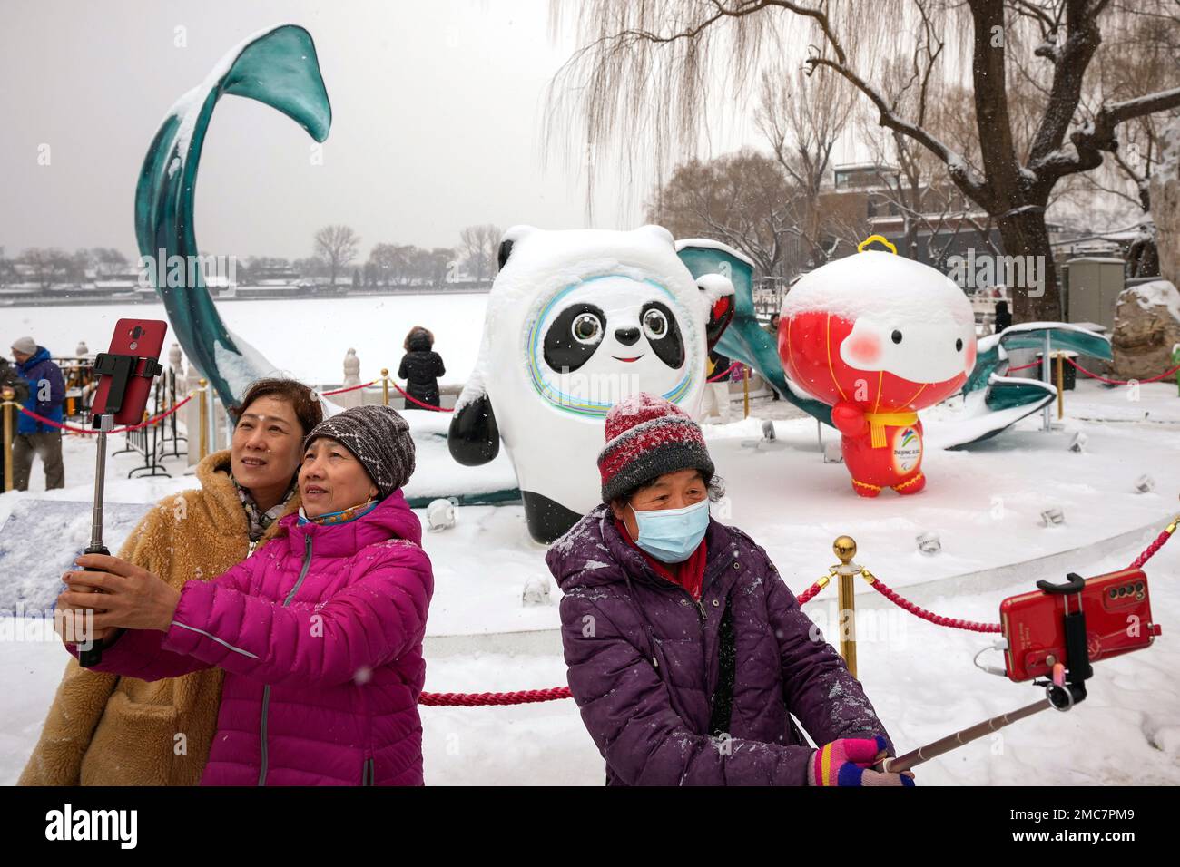 Residents take selfie with the snow covered mascot for the Winter ...