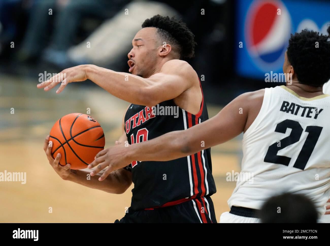 Utah guard Marco Anthony, left, pulls in a rebound as Colorado forward ...