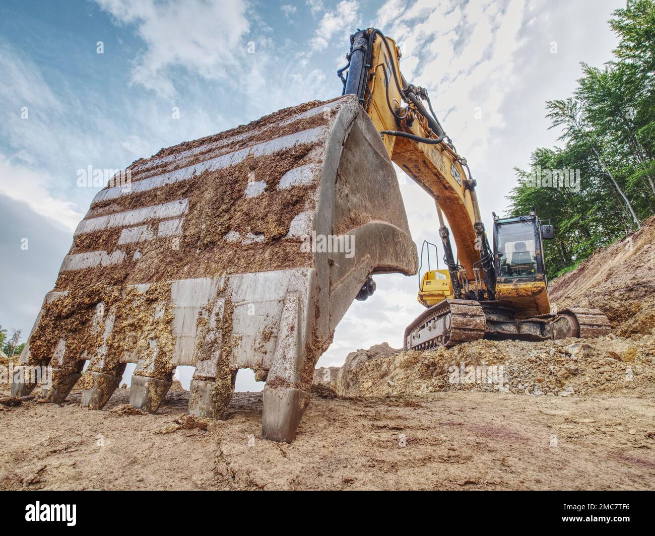 Track type loader is mining stones in opencast mining quarry. Heavy ...
