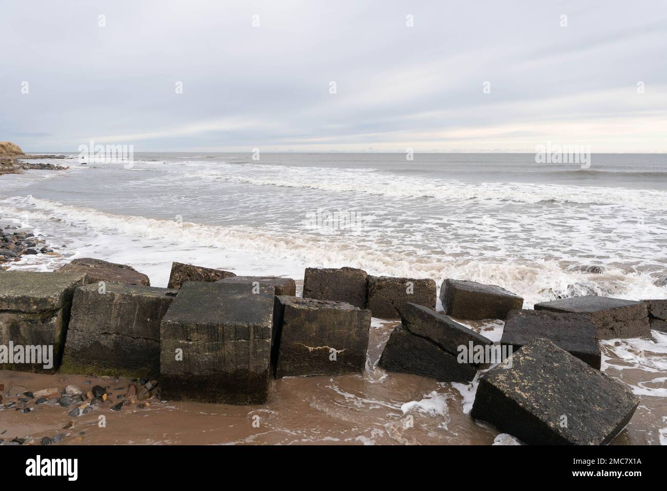 Concrete blocks and drainage channel on the Northumberland coast, UK ...