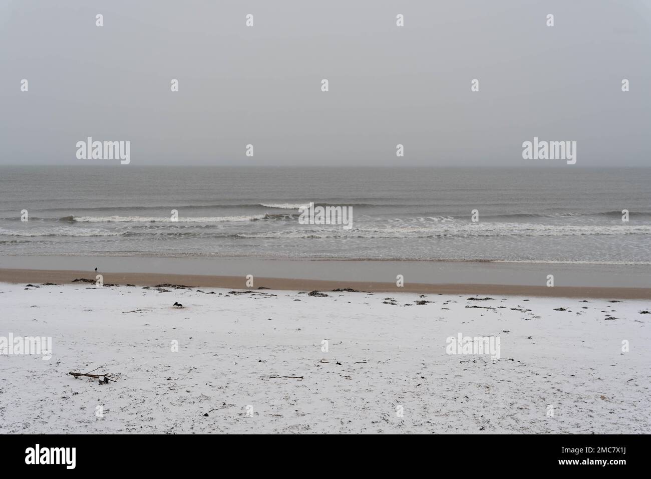 A beach in winter with snow on the sand Stock Photo - Alamy