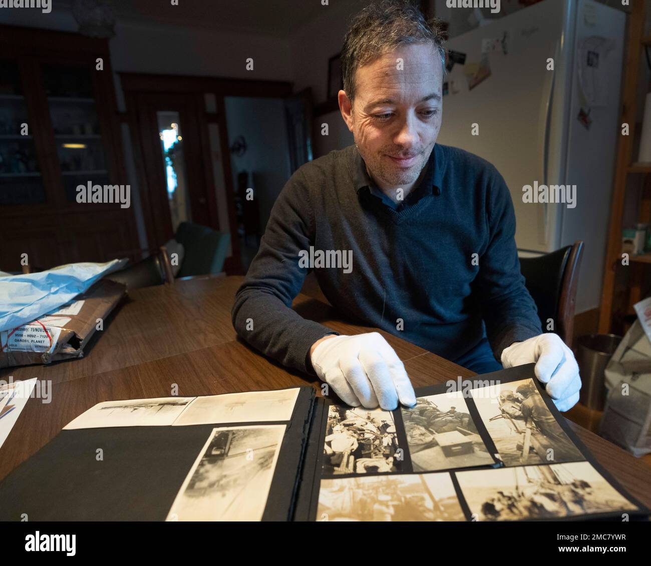 Historian David Saint-Pierre shows photos of the salvage operation from ...
