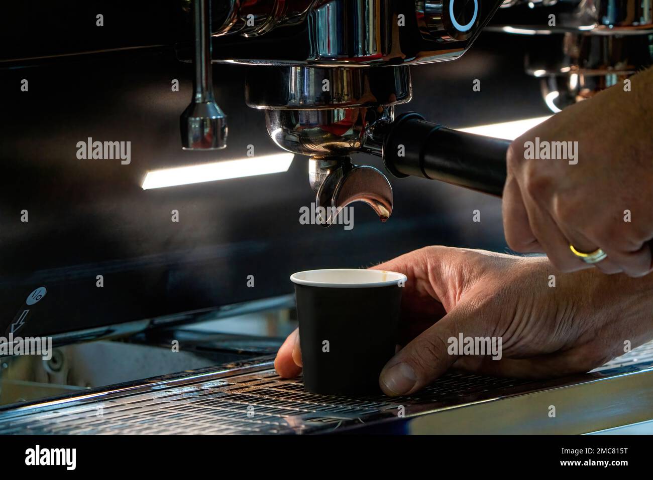 Barista making coffee in front of the coffee machine, barista hands ...