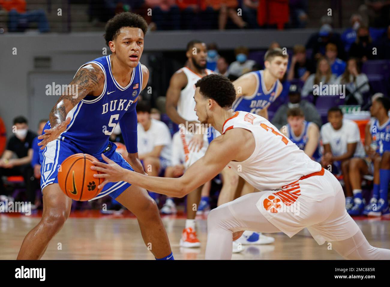 Clemson guard Chase Hunter, right, passes around Duke forward Paolo ...