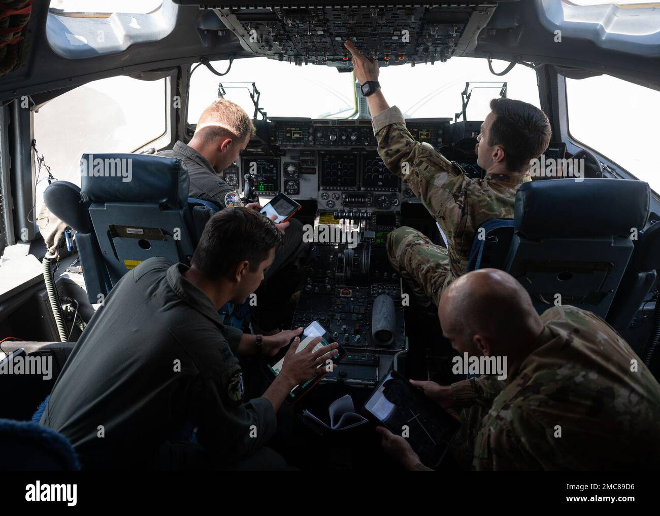 A crew of C-17 Globemaster III pilots perform preflight duties inside ...