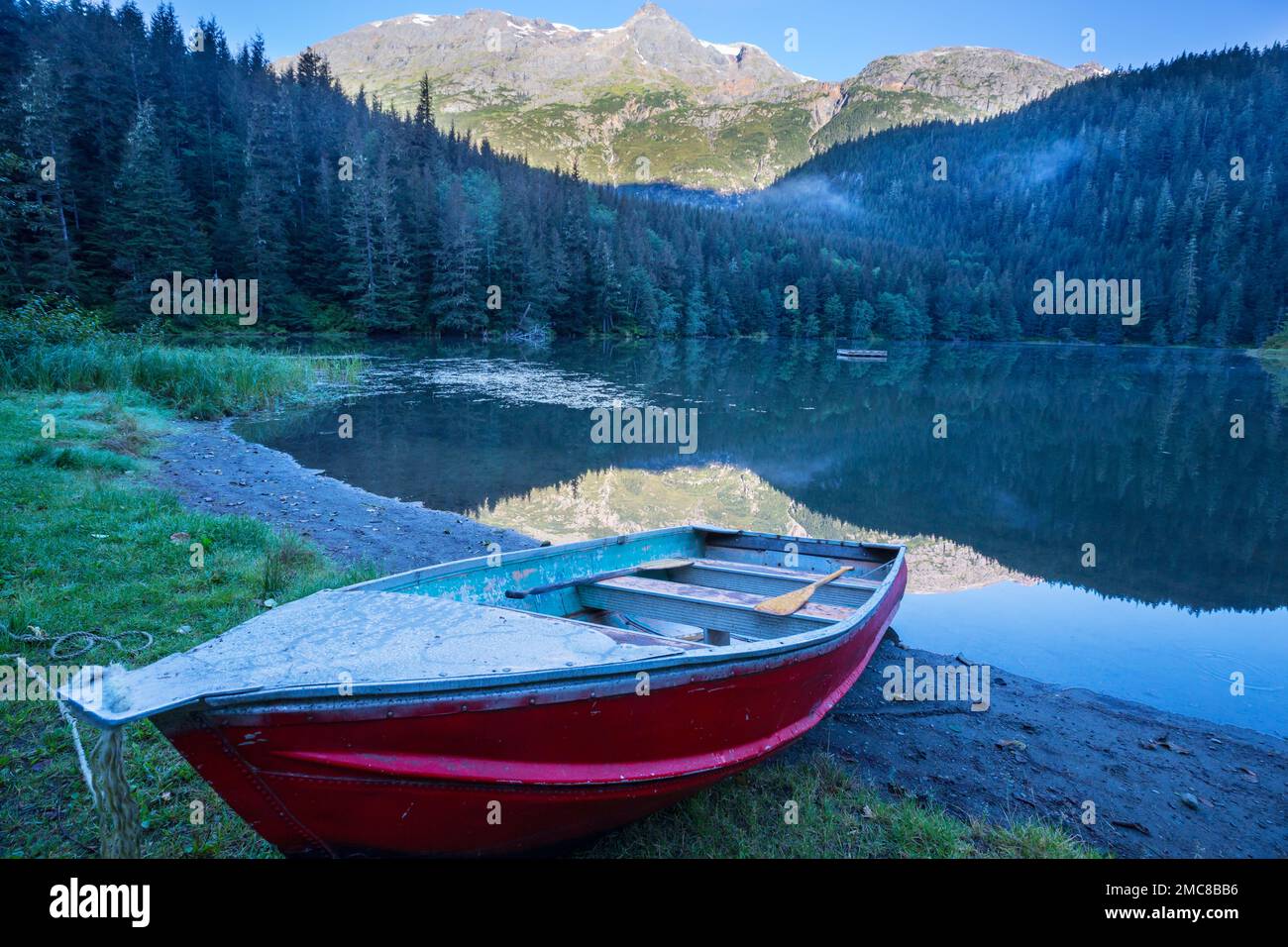 Boat on a beautiful mountains lake Stock Photo - Alamy