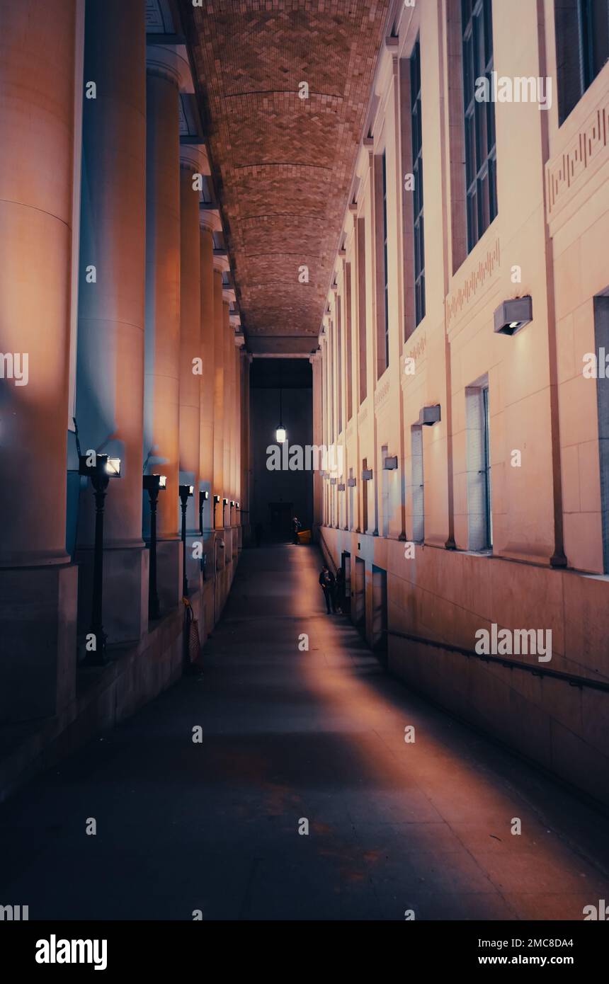 A vertical shot of a narrow hallway alongside the columns with an ...