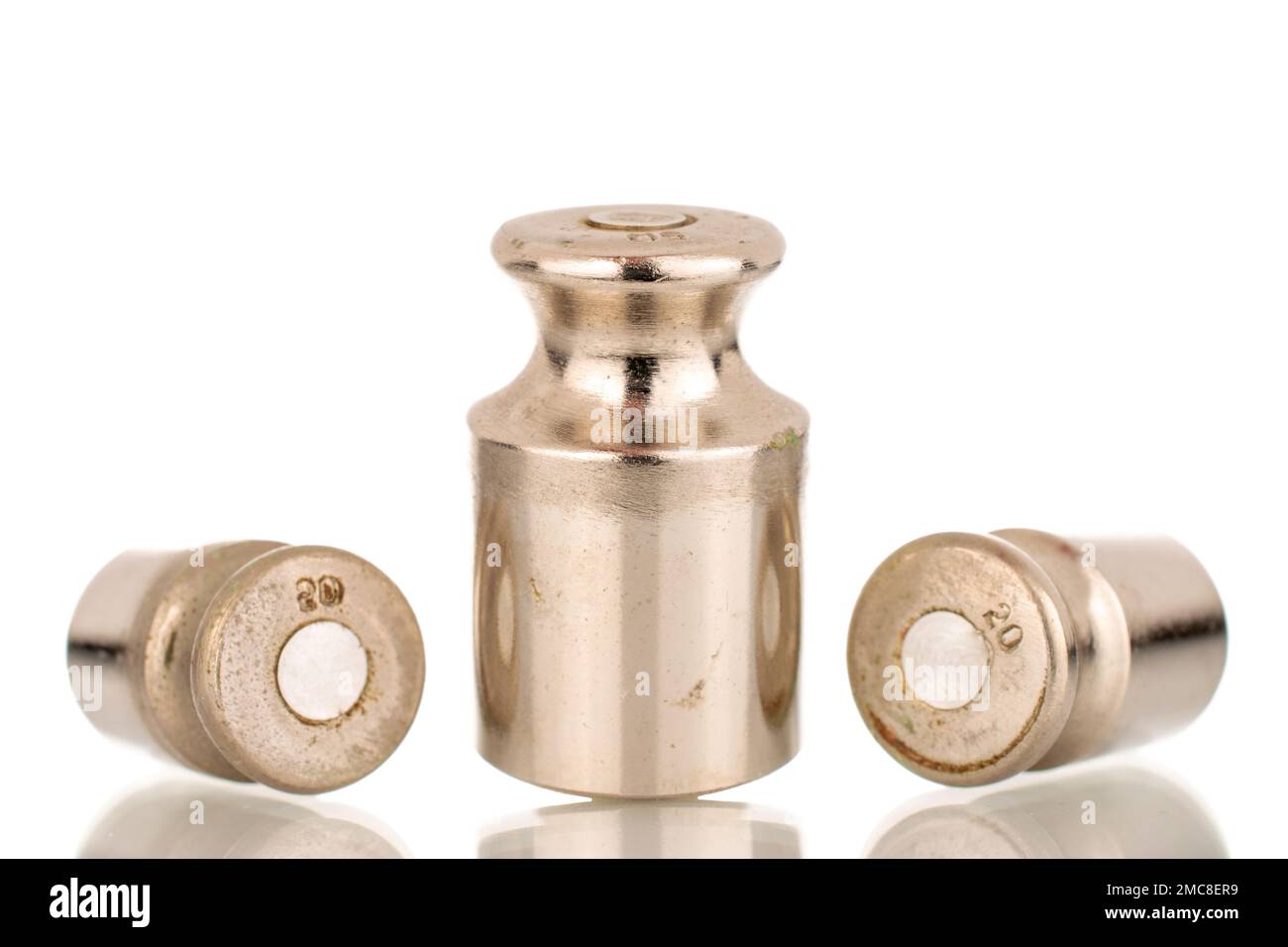 Three metal weights for old jewelry scales, macro, isolated on white ...