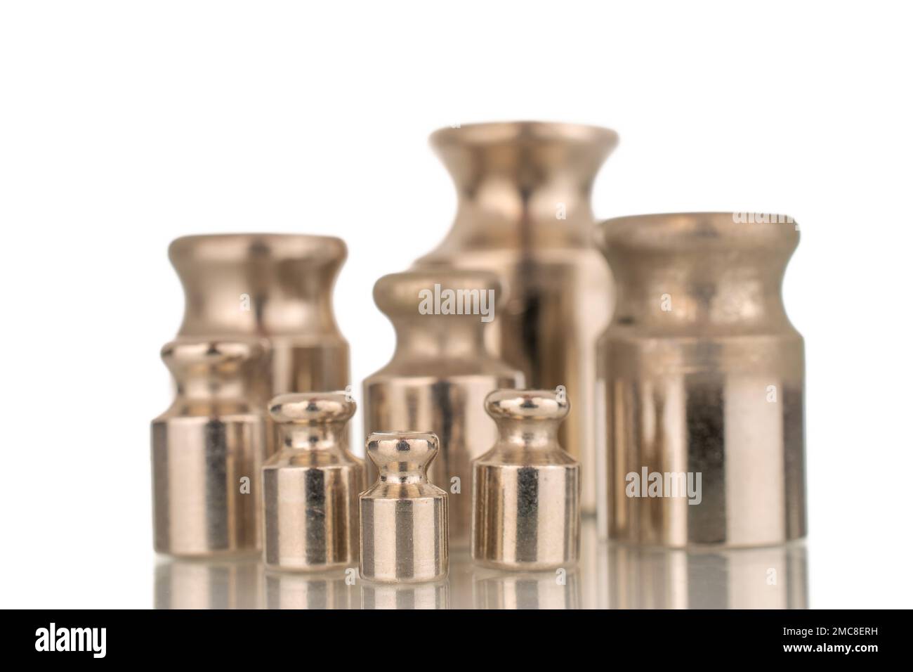 Several metal weights for old jewelry scales, macro, isolated on white ...