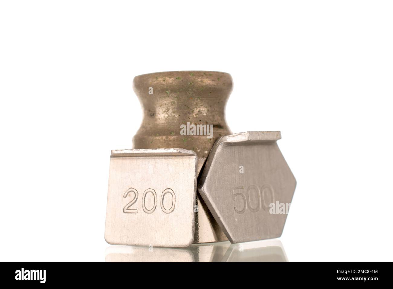 Three metal weights for old jewelry scales, macro, isolated on white ...