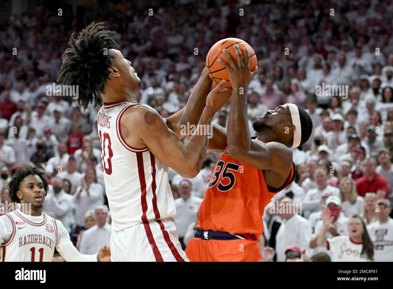 Arkansas forward Jaylin Williams (10) and Auburn guard Devan Cambridge (35) fight for a rebound ...