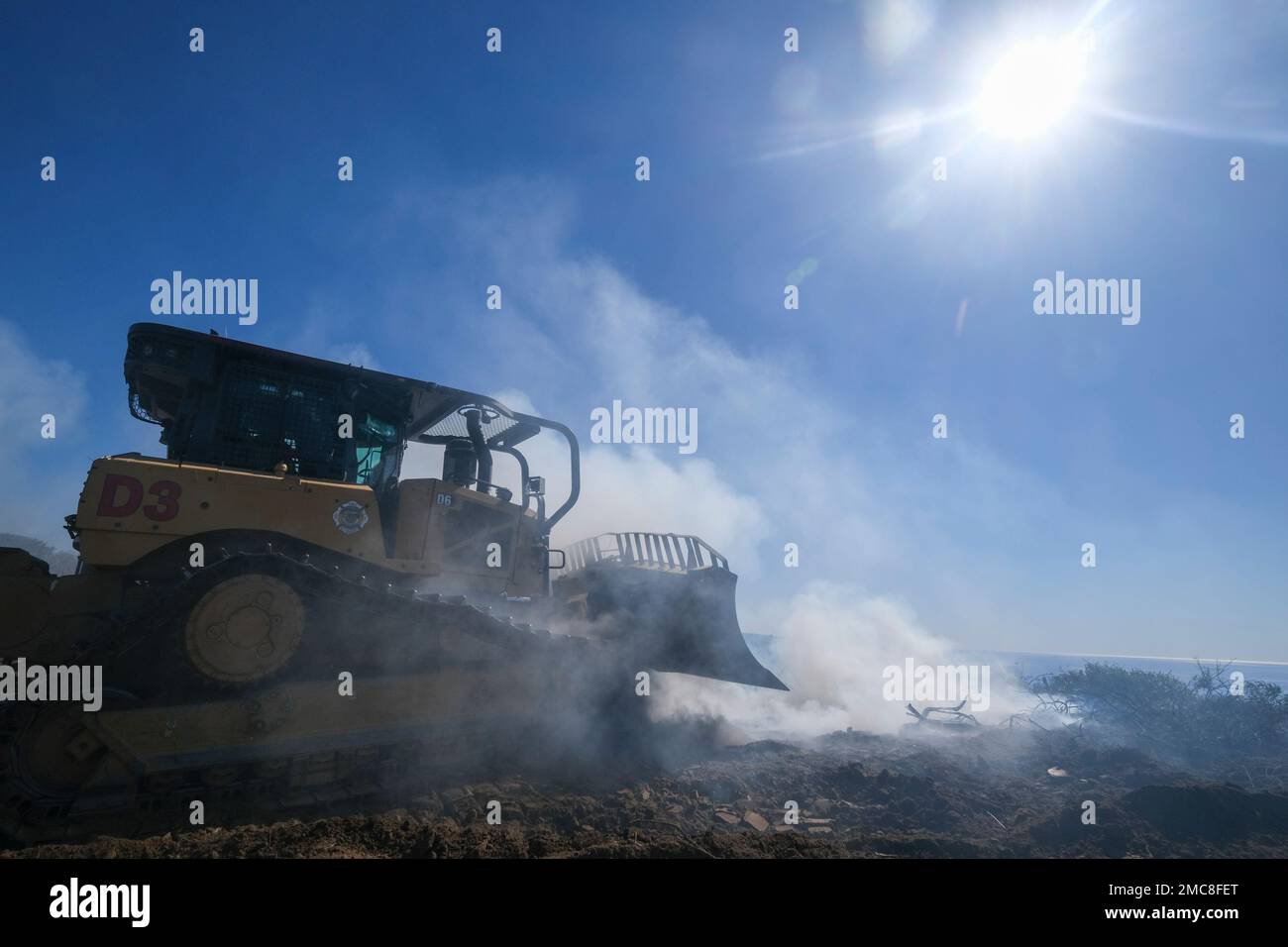 A bulldozer works to build a fire line on a wildfire Thursday, Feb. 10 ...