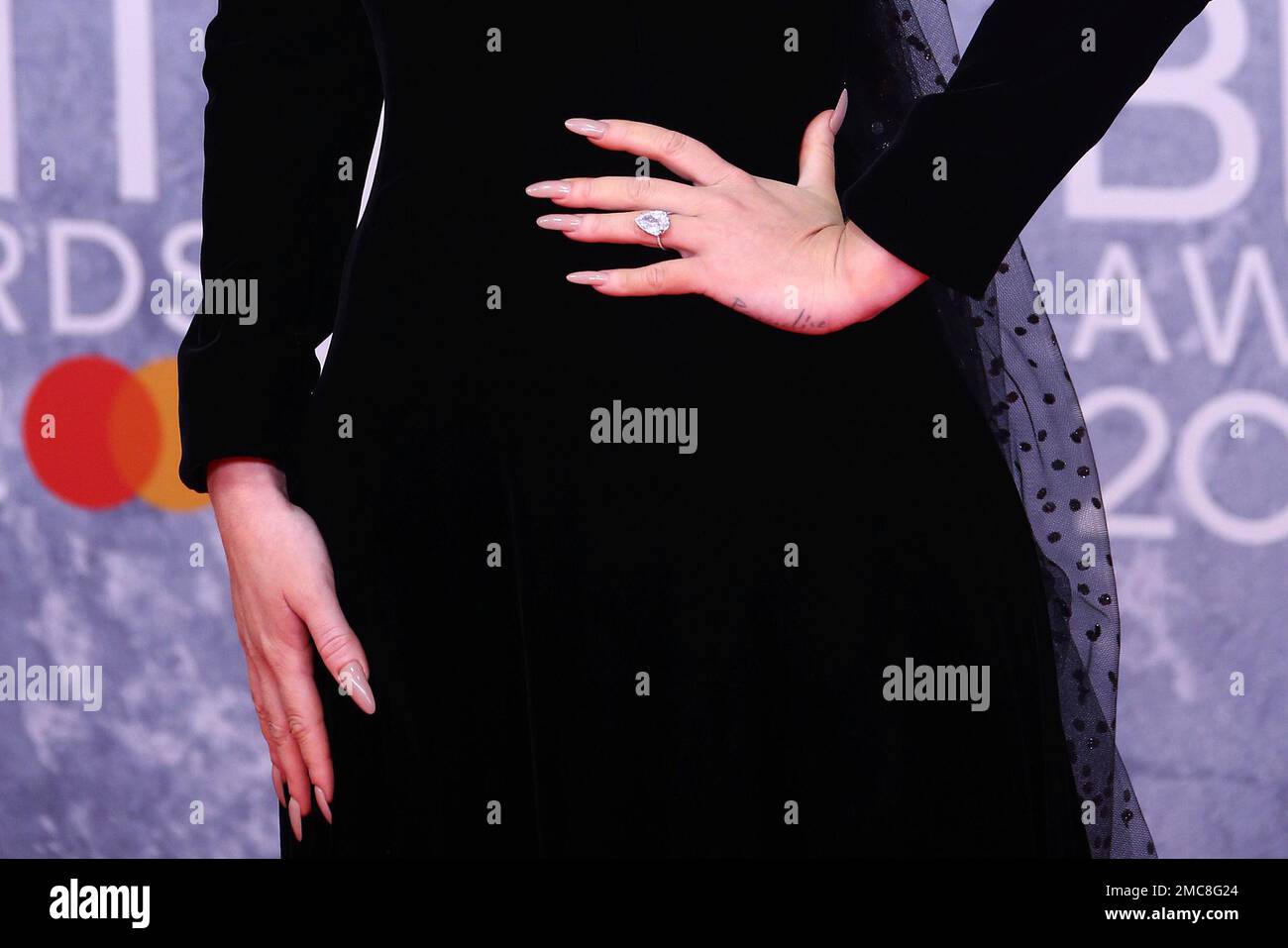 The hands of Adele and ring, on display as she poses for photographers ...