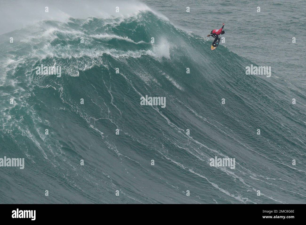 Surfer Lucas Chianca does a 360 aerial turn exiting a wave during the ...