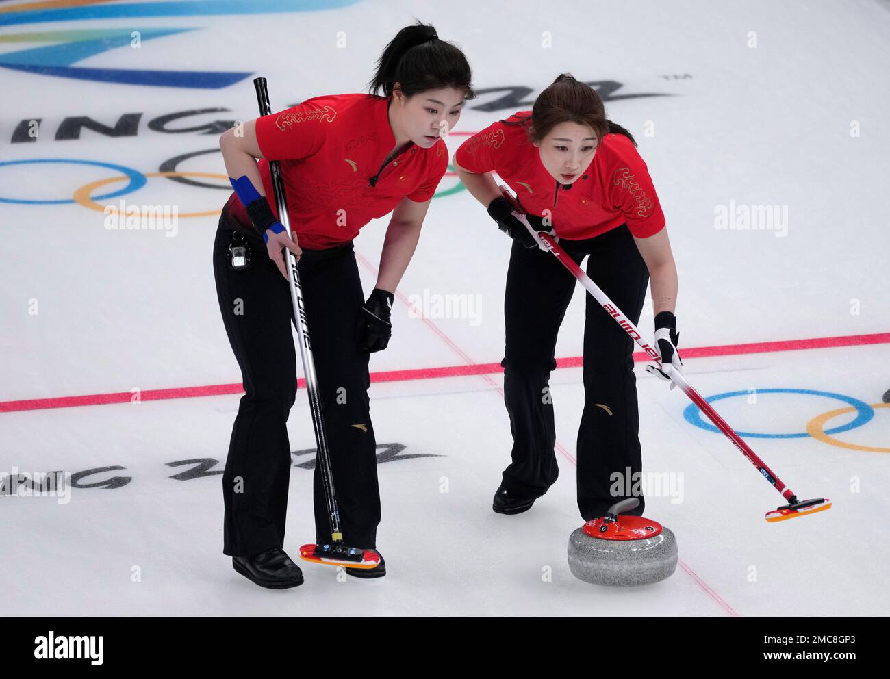 China's Zhang Lijun, right, and Dong Ziqi, sweep the ice, during the ...