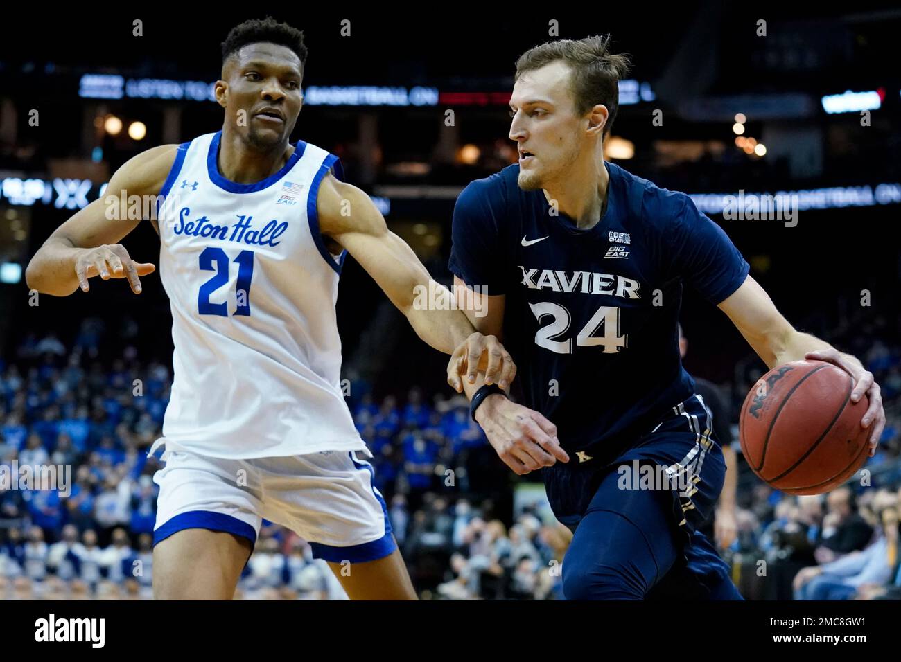 Xavier's Jack Nunge (24) drives past Seton Hall's Ike Obiagu (21 ...