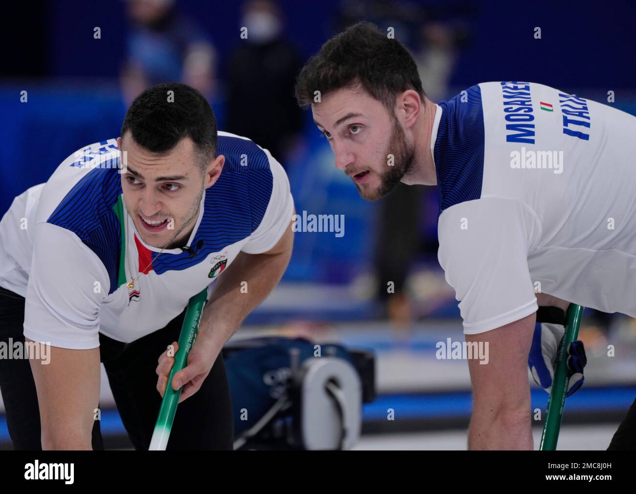 Italy's Sebastiano Arman and Amos Mosaner, sweep the ice, during the ...