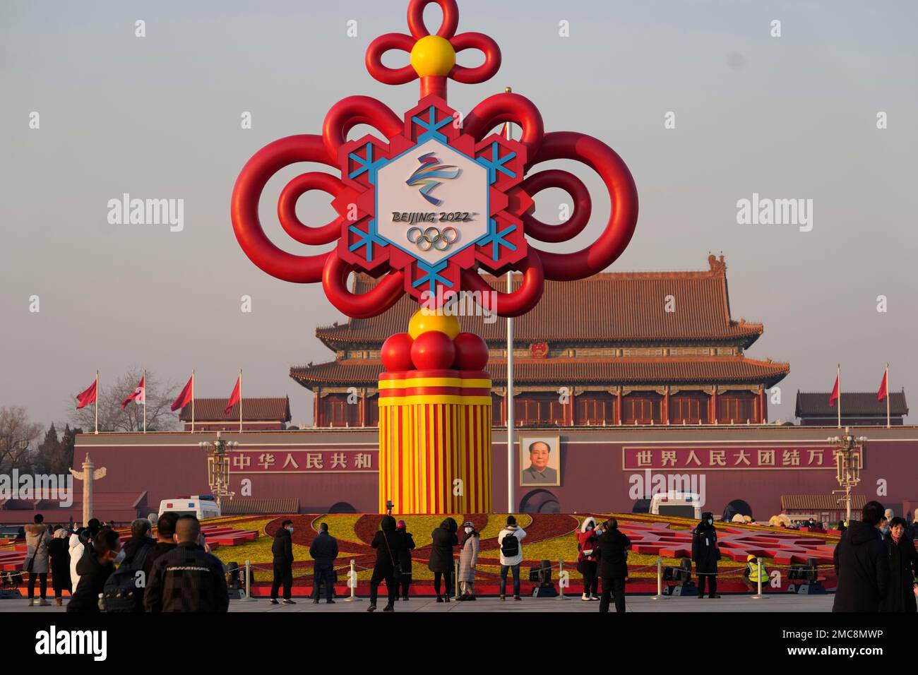 Residents look at a gigantic red ribbon 2022 Winter Olympics sculpture ...