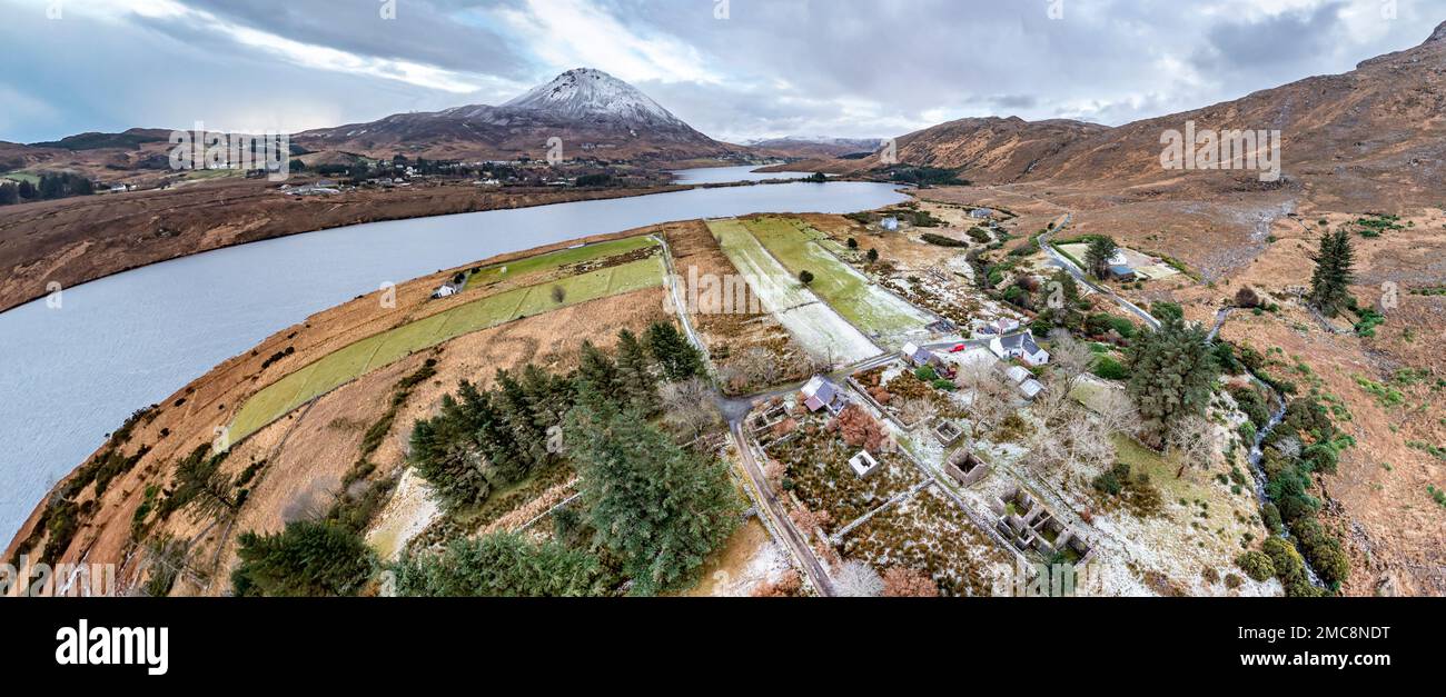 Aerial view of the Dunlewey Ghost village with the snow covered Mount ...