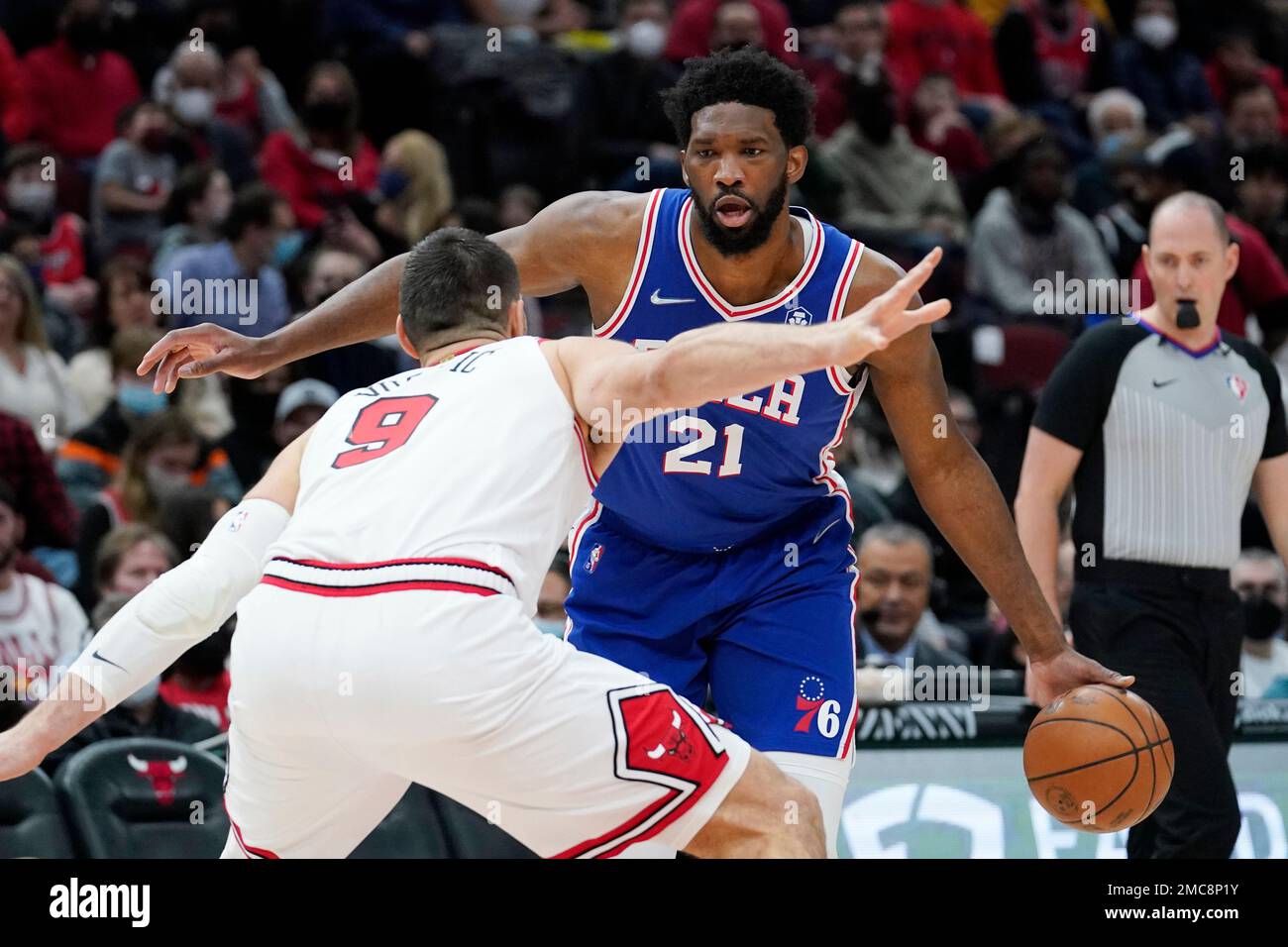 Philadelphia 76ers center Joel Embiid, right, drives against Chicago ...