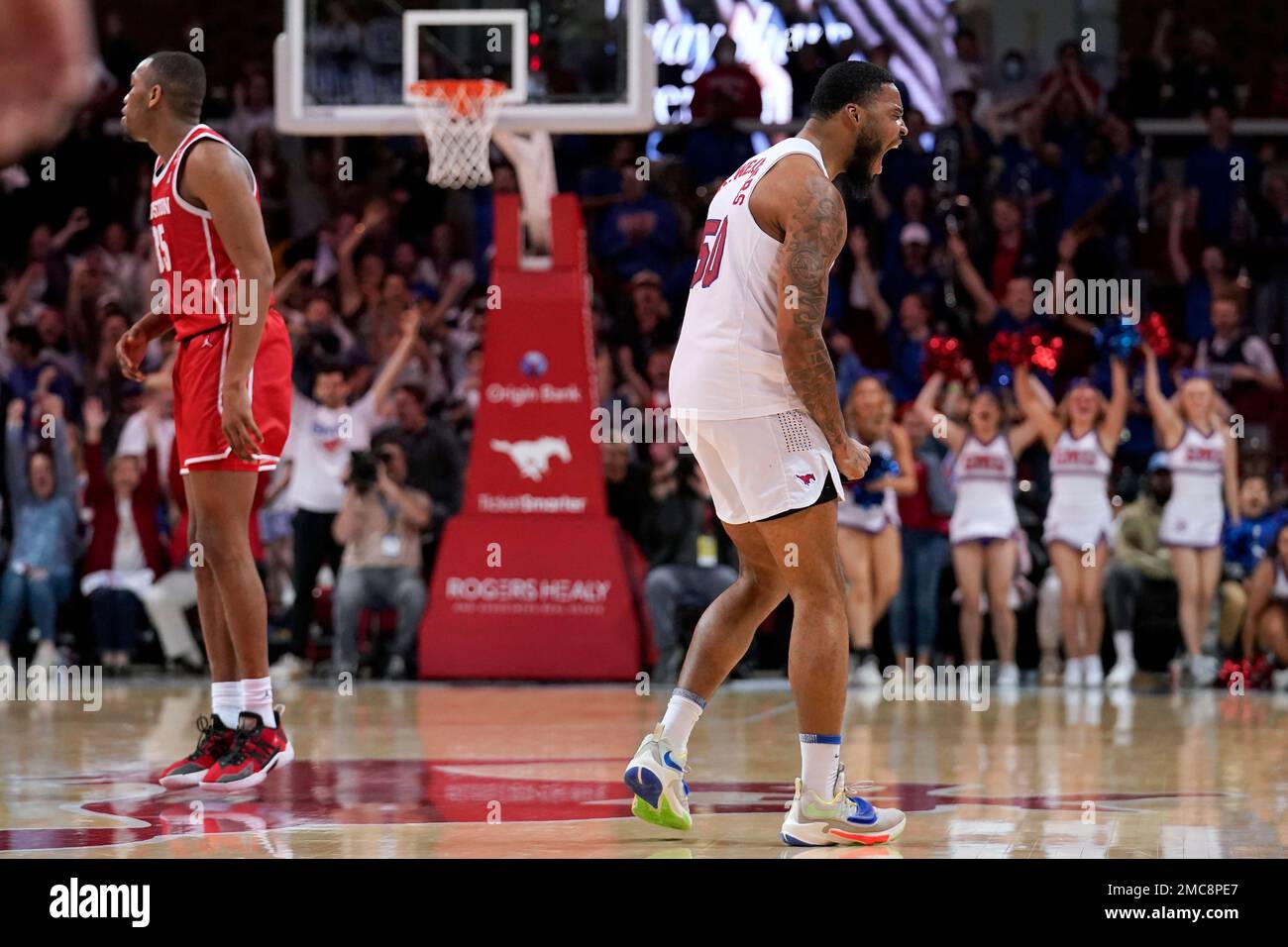 Houston's Fabian White Jr., left, looks downcourt as SMU's Marcus ...