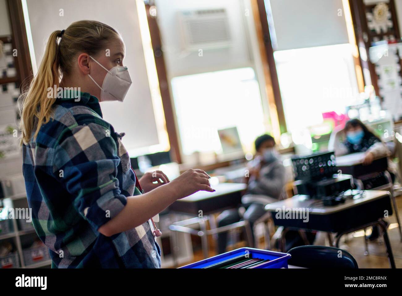 Music teacher Kristen Huetteman talks with fourth grade students at ...