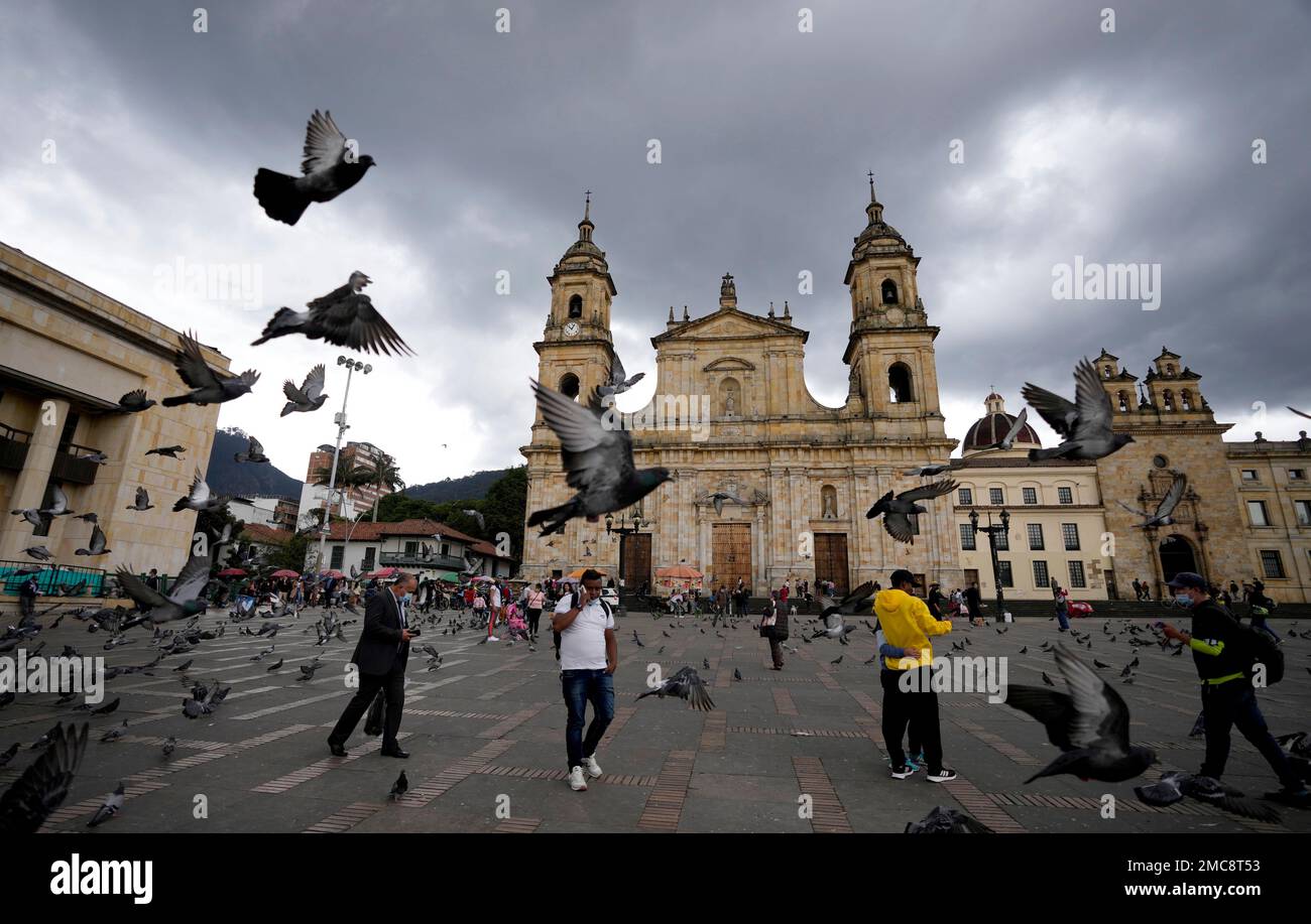 People walk in Bolivar Square, in Bogota, Colombia, Wednesday, Feb. 9 ...