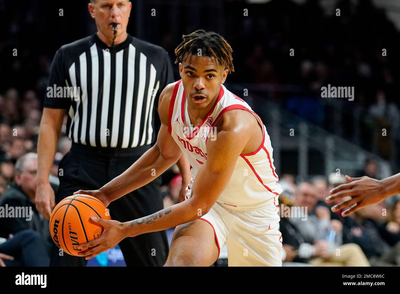 Houston guard Ramon Walker Jr. (3) dibbles past Cincinnati's Mika Adams ...