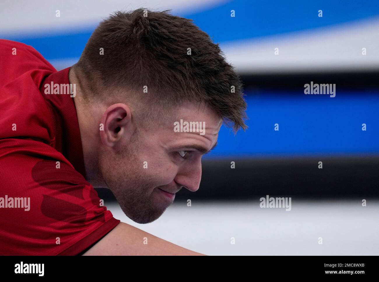 Denmark's Mads Norgaard, throws a rock, during the men's curling match ...