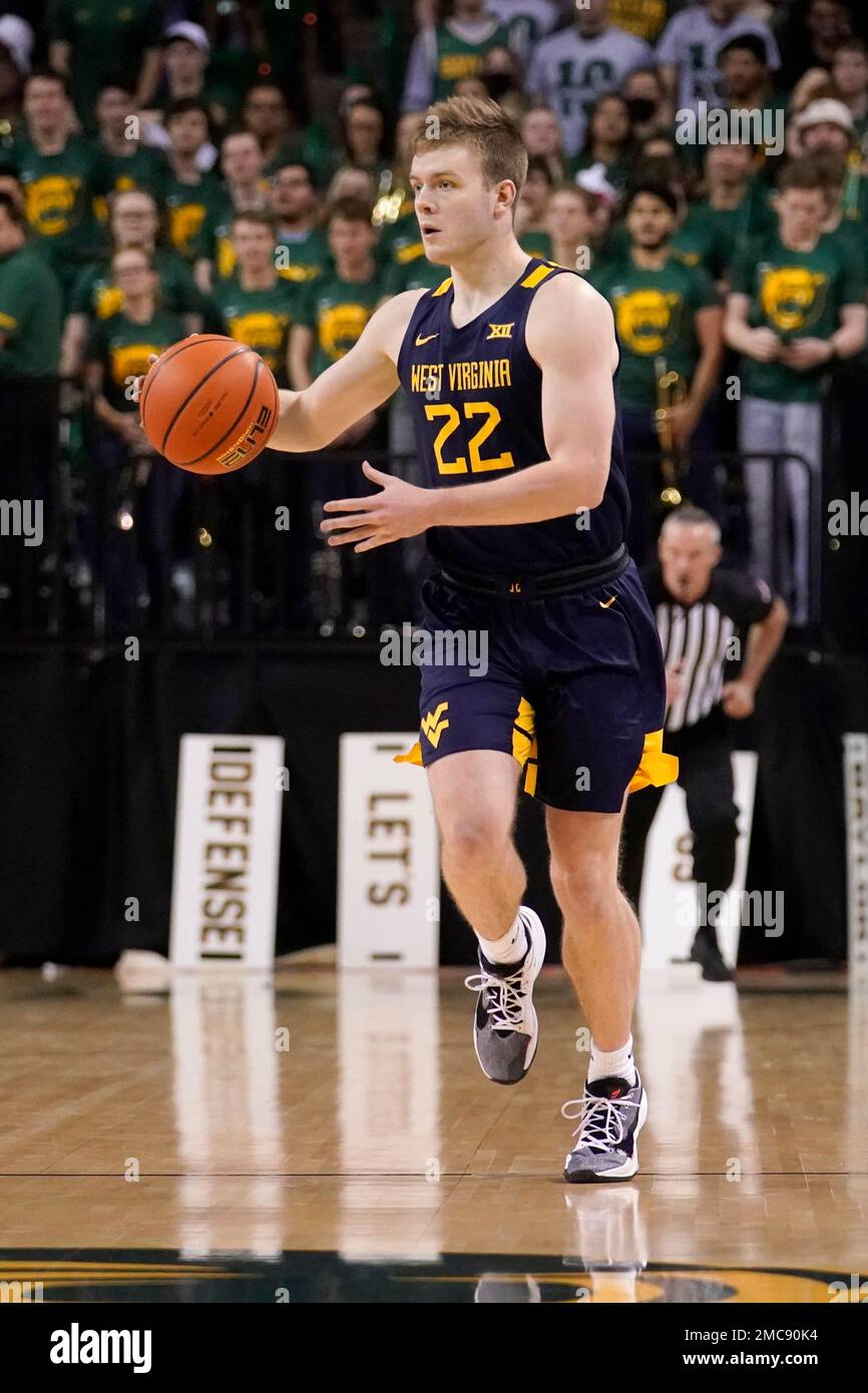 West Virginia guard Sean McNeil advances the ball against Baylor during ...