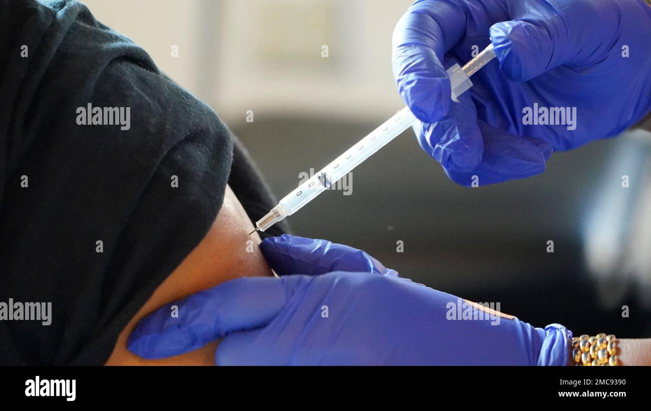 A Jackson, Miss., resident receives a Pfizer booster shot from Linda ...