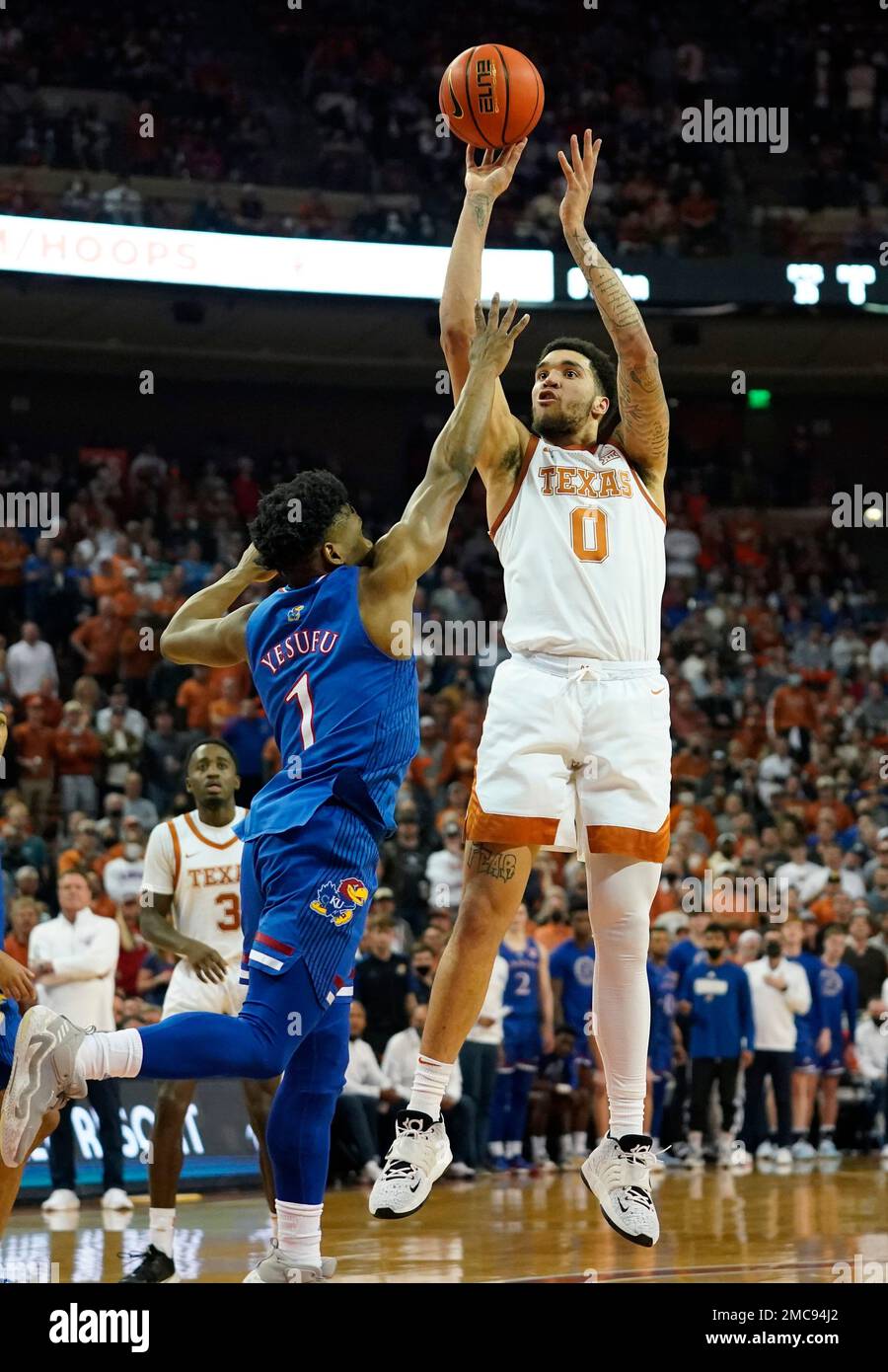 Texas forward Timmy Allen (0) shoots over Kansas guard Joseph Yesufu (1 ...