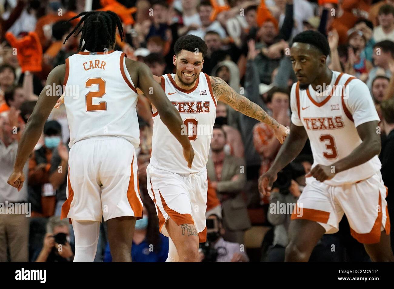 Texas forward Timmy Allen (0) celebrates a play with teammates Marcus ...
