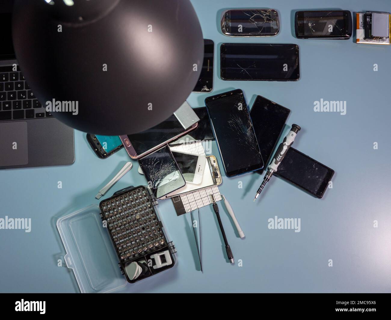 Old broken smartphone and repair tool. The concept of computer ...