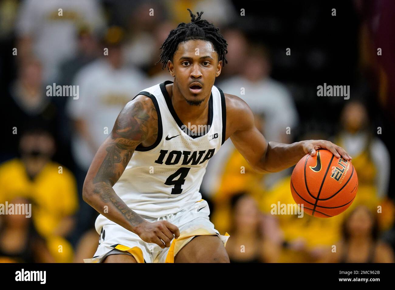 Iowa guard Ahron Ulis (4) drives up court during an NCAA college ...