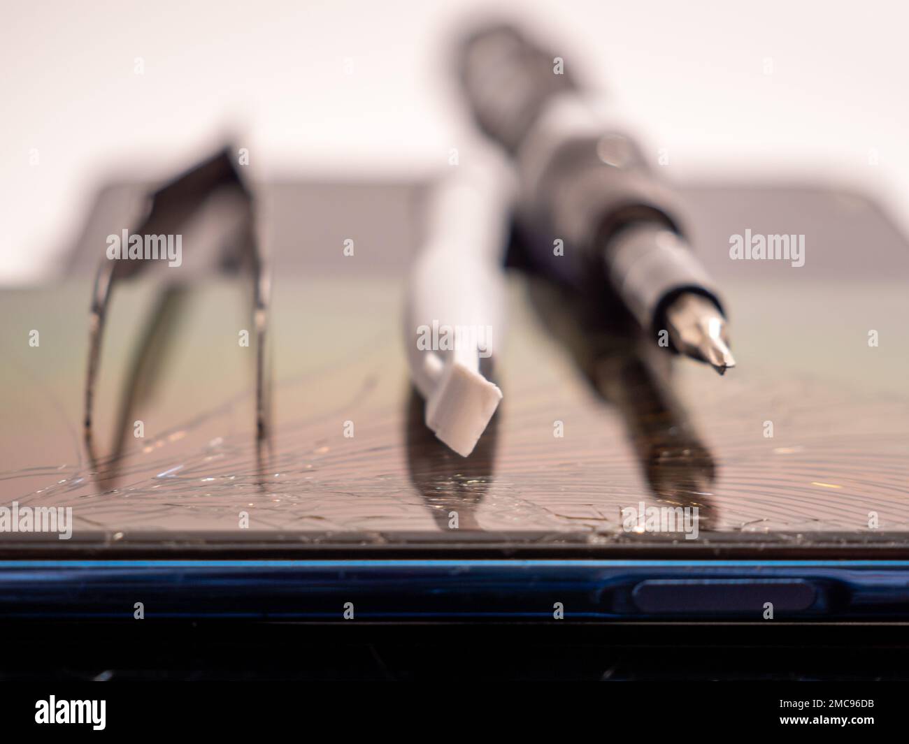 Old broken smartphone and repair tool. The concept of computer ...