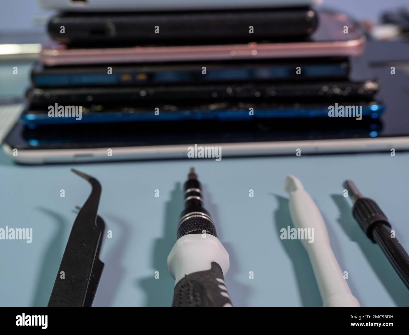 Old broken smartphone and repair tool. The concept of computer ...