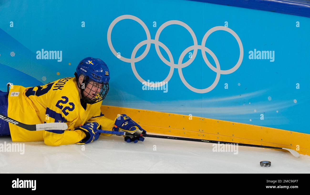 Sweden's Linn Peterson (22) digs the puck out of a corner during a ...