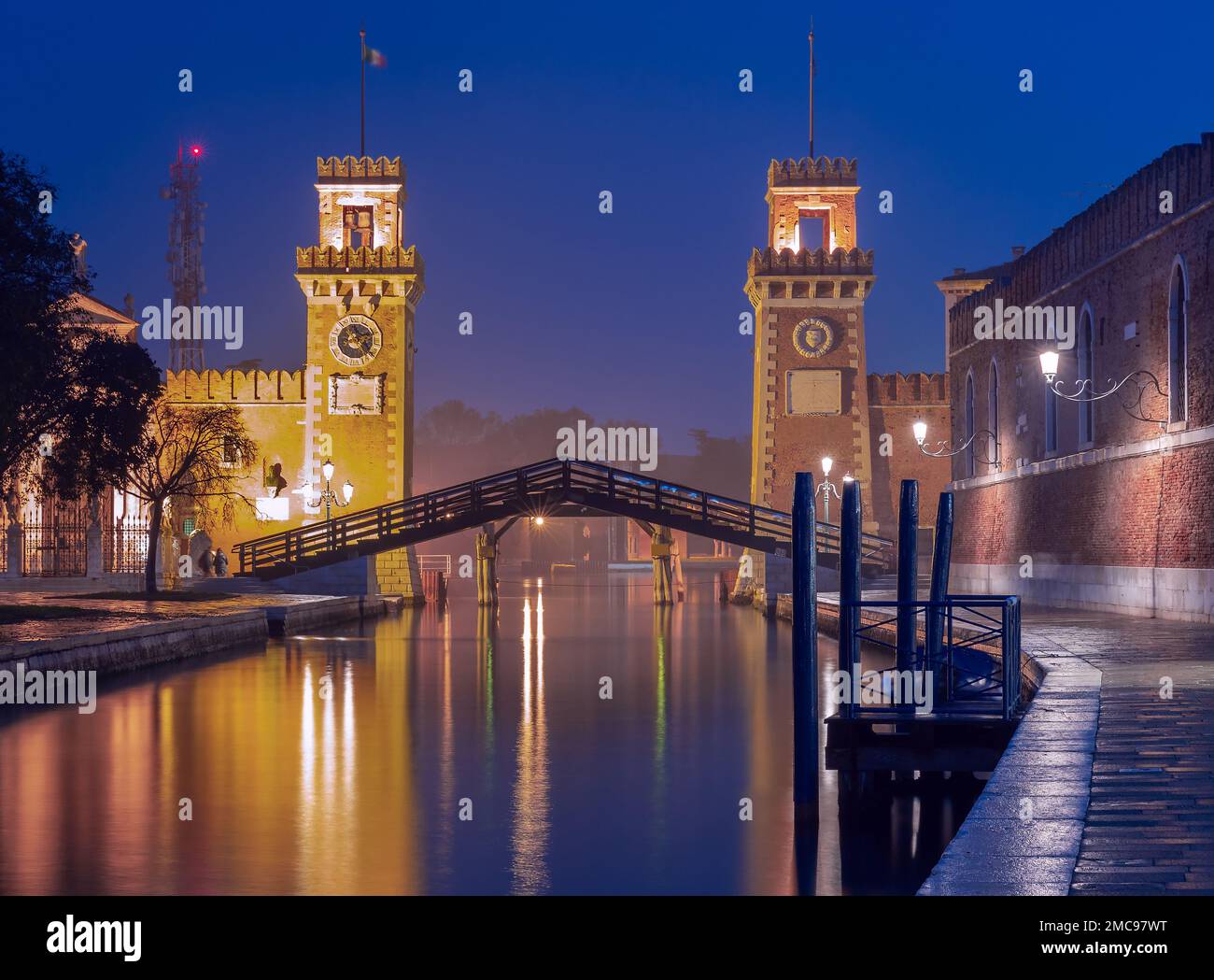Old medieval armory towers and a bridge over a canal at dawn. Venice ...