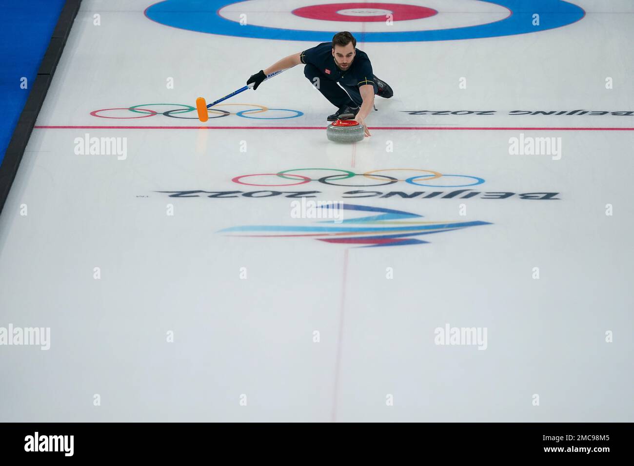 Oskar Eriksson, of Sweden, throws a rock during the mixed doubles ...