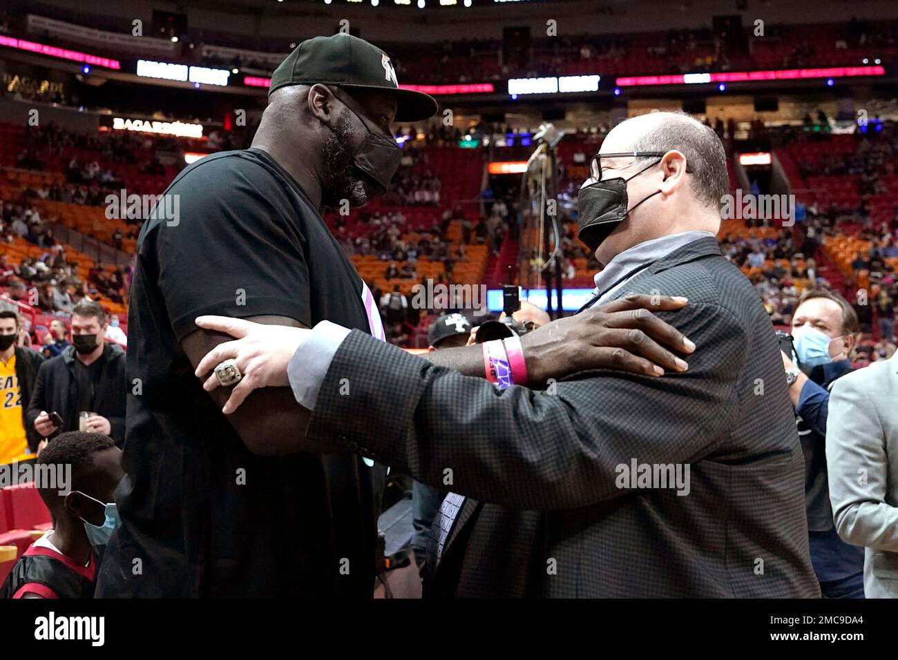 Former NBA basketball player Shaquille O' Neal, left, talks with Miami ...