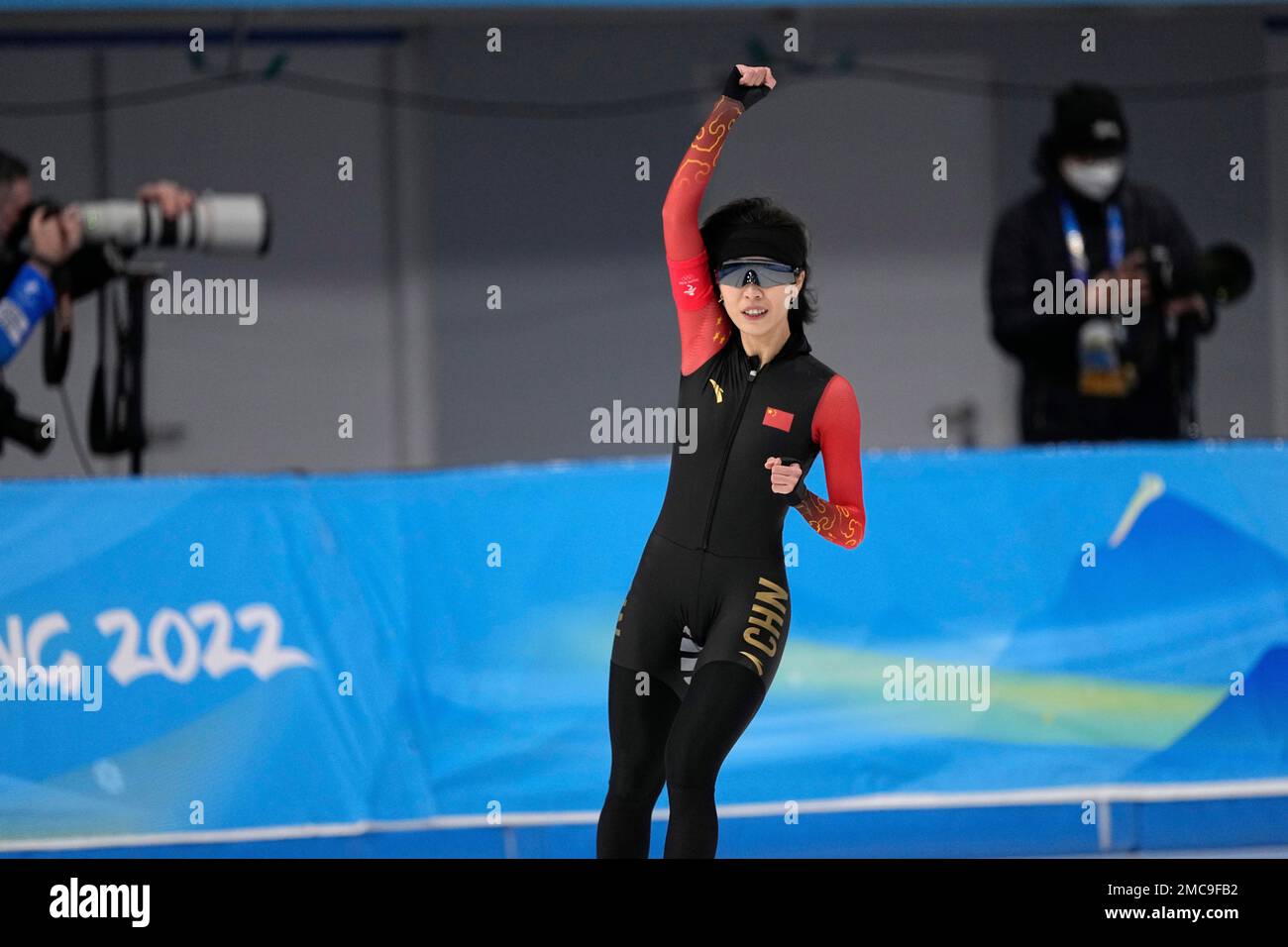 Ahenaer Adake of China reacts after finishing her heat in the women's ...