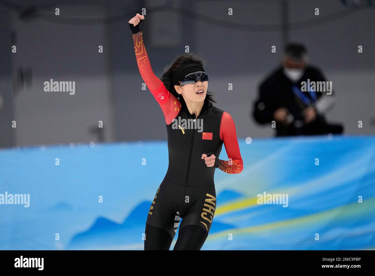 Ahenaer Adake of China reacts after finishing her heat in the women's ...