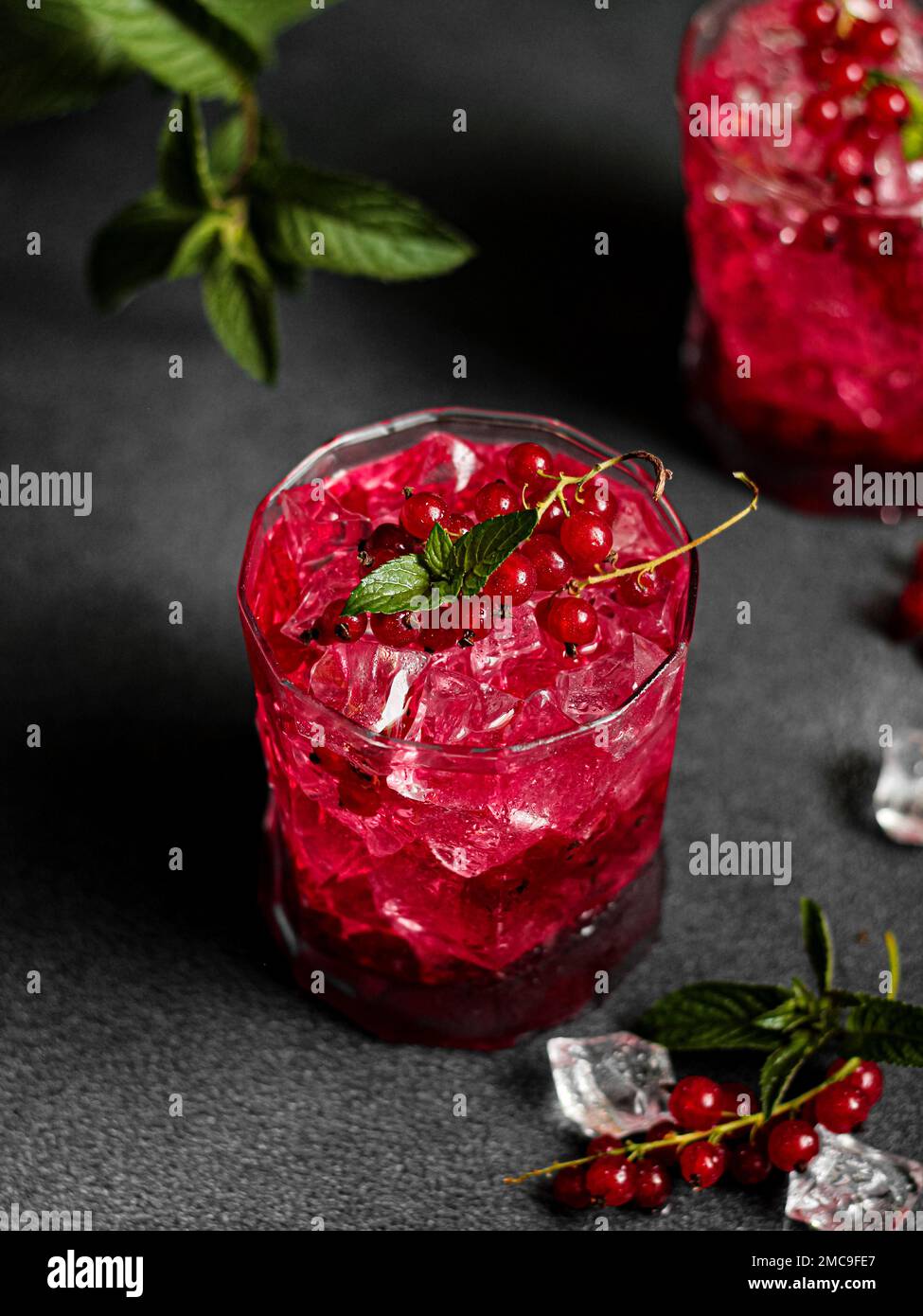 A vertical shot of cocktail with red currant and mint Stock Photo - Alamy