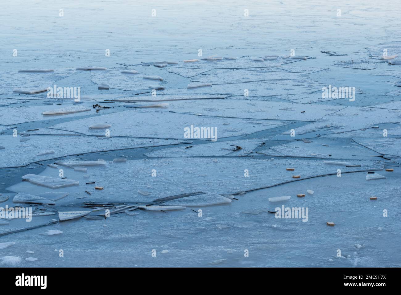 Broken ice lake. Snowy cold winter. Ice drift photo. Spring is coming ...
