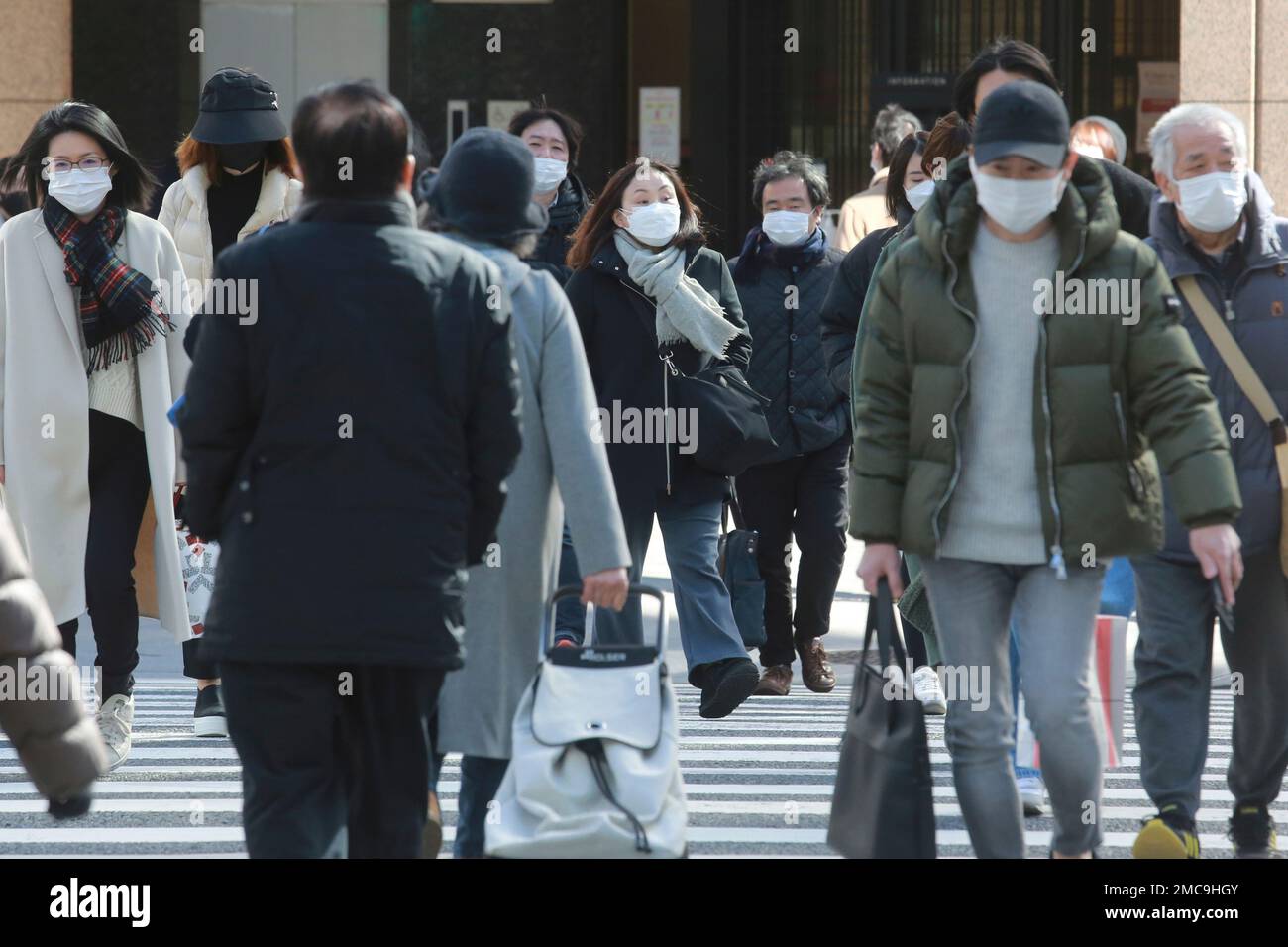 People wearing face masks to protect against the spread of the ...