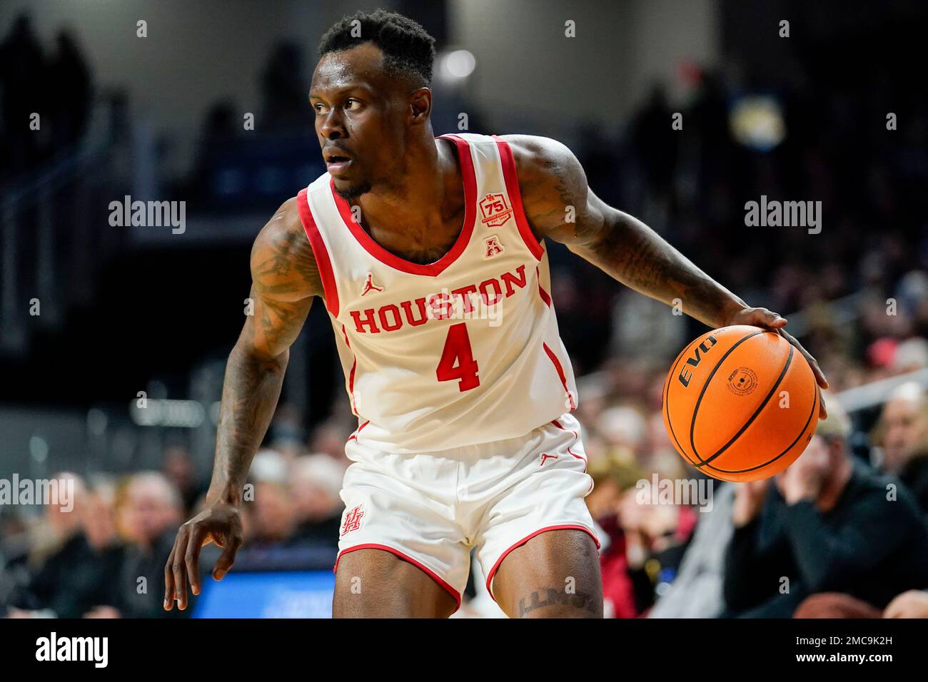 Houston guard Taze Moore (4) dribbles during the first half of an NCAA ...